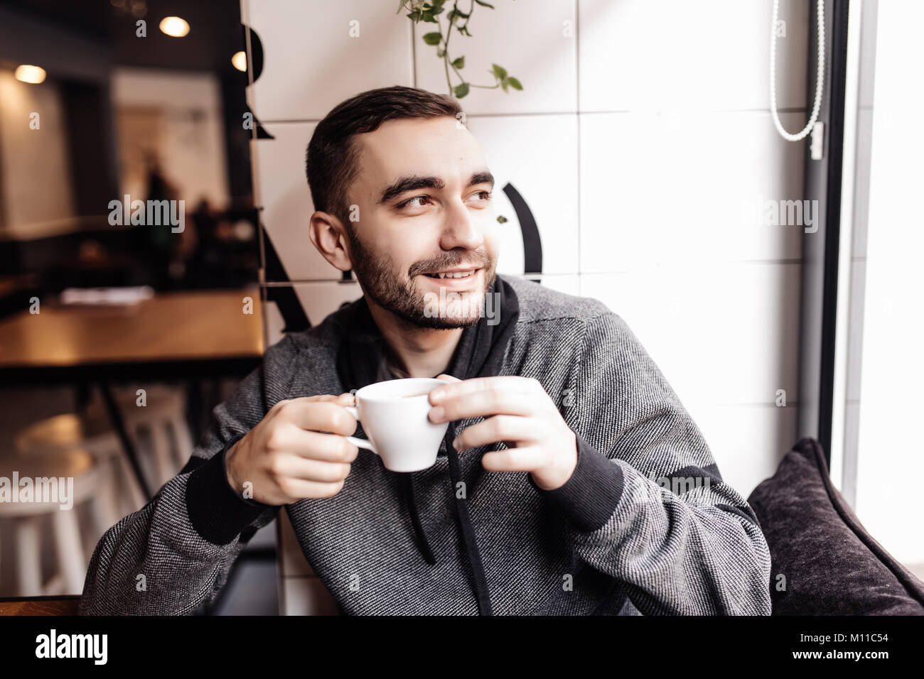 Man drinking a cup of coffee in the cafe Stock Photo - Alamy