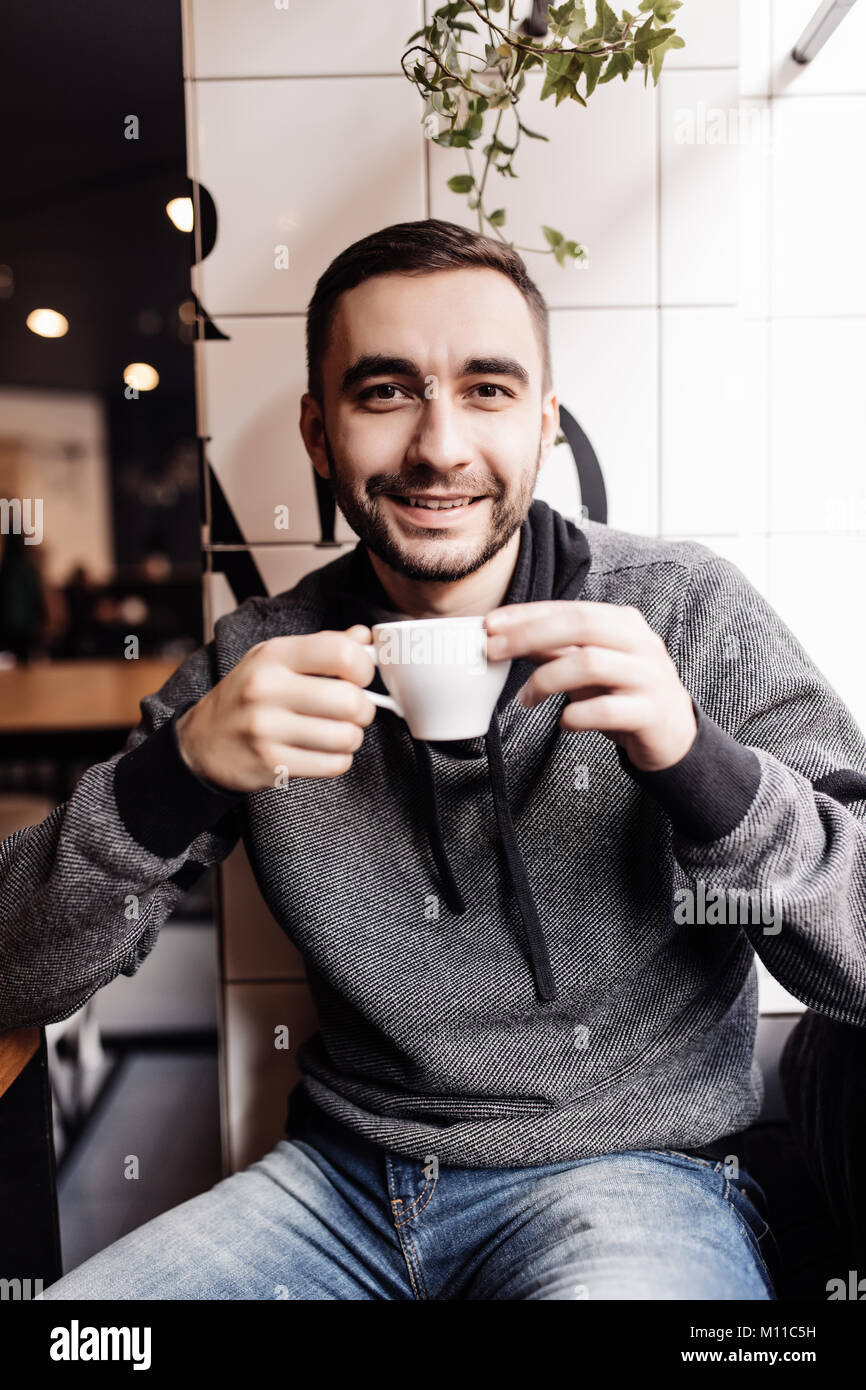 Man drinking a cup of coffee in the cafe Stock Photo - Alamy