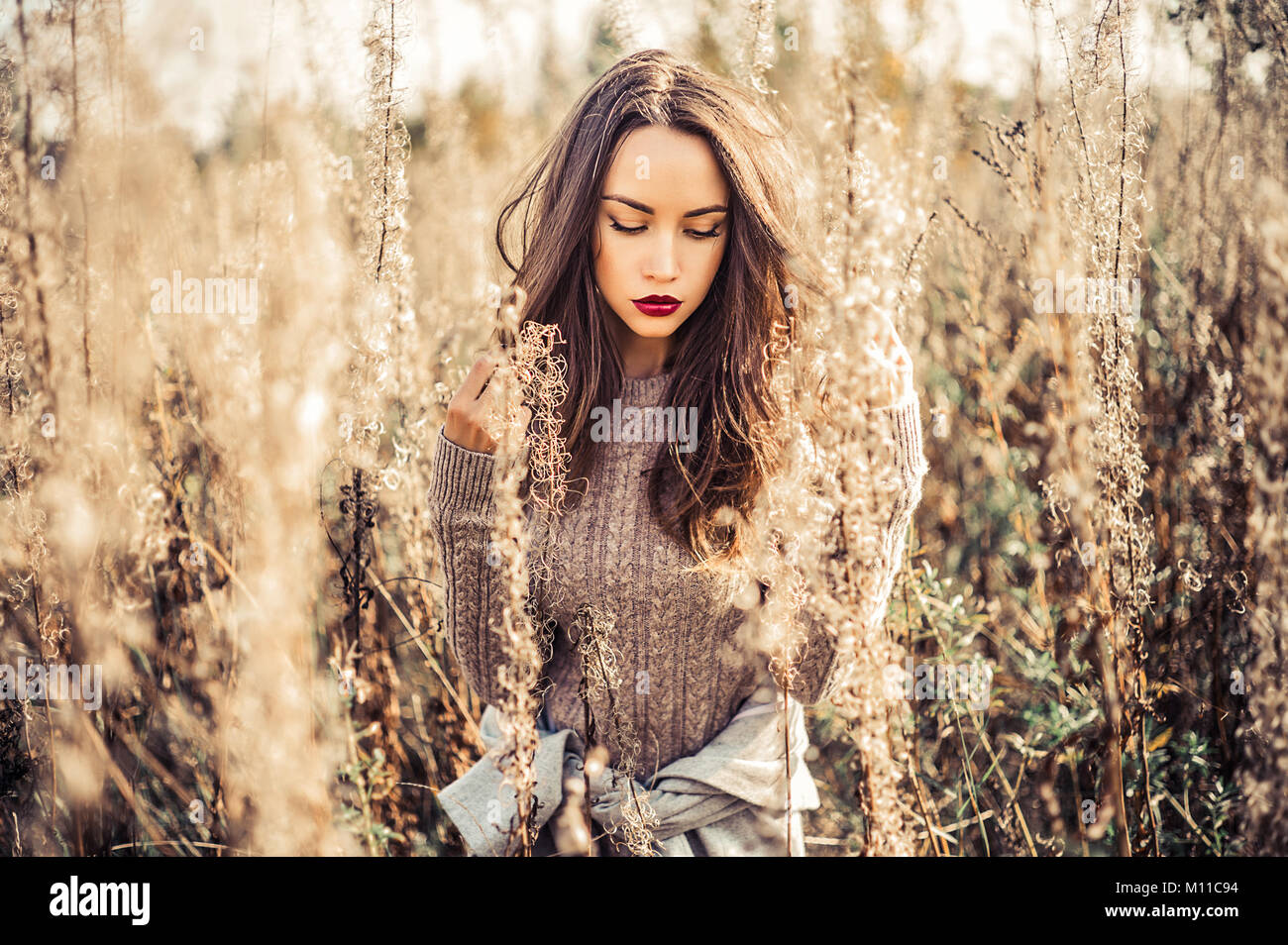Outdoor fashion photo of young beautiful lady in autumn landscape with ...