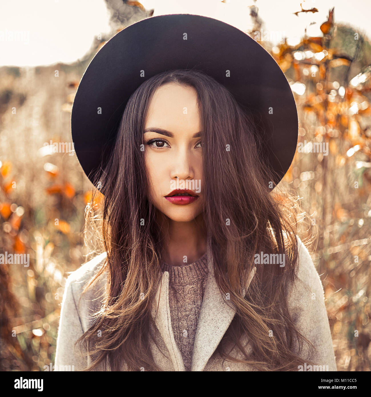 Outdoor fashion photo of young beautiful lady in autumn landscape with ...