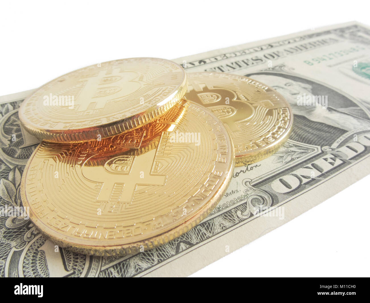 Some Bitcoin and one dollar bill in white background Stock Photo - Alamy