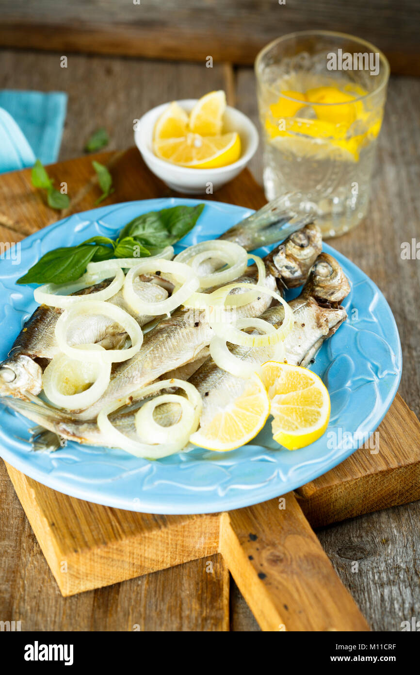 Fish, cooked with milk, onion and pepper Stock Photo - Alamy