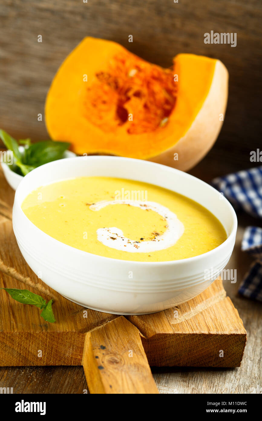 Pumpkin soup with basil and cream Stock Photo - Alamy