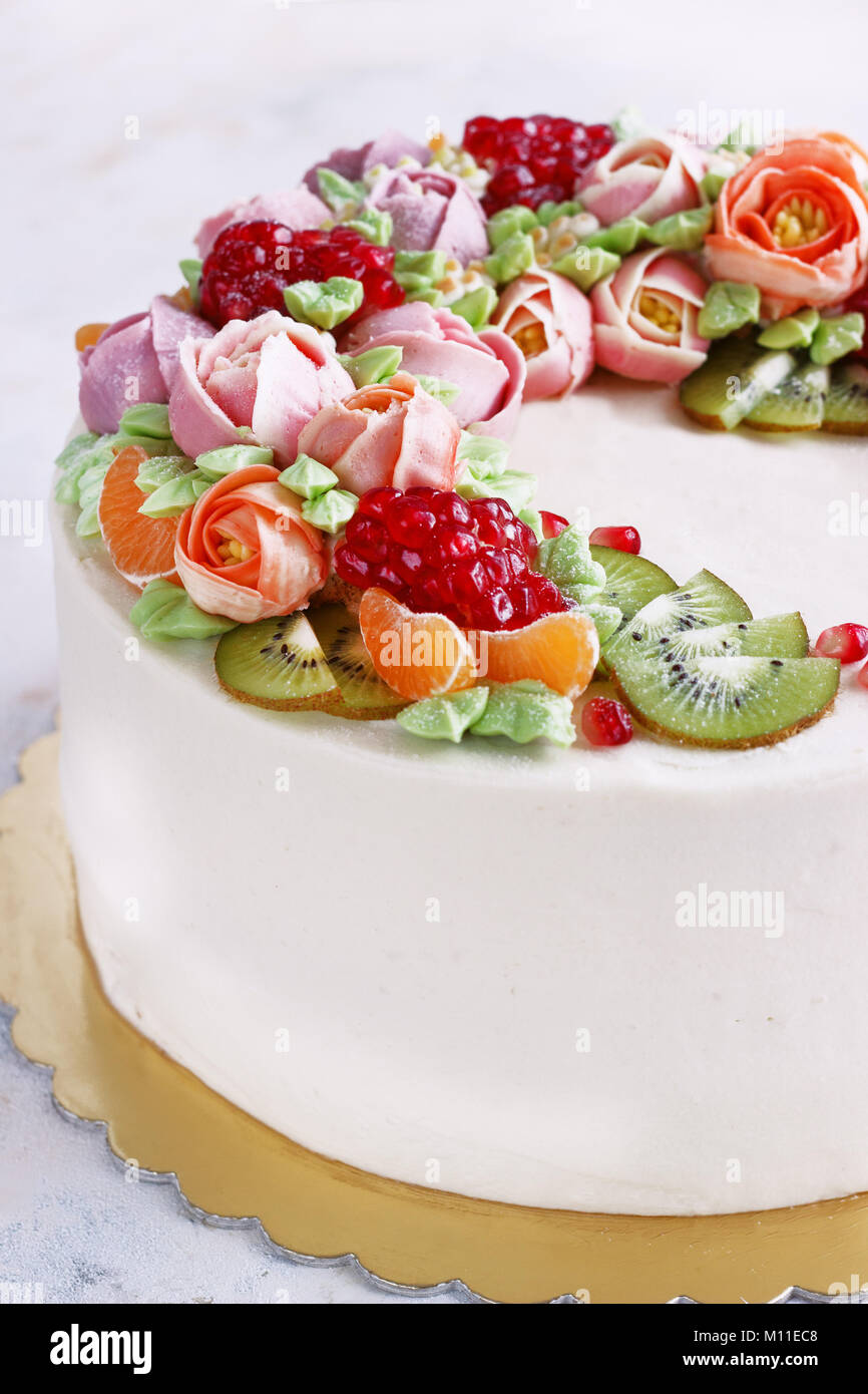 Festive cake with cream flowers and fruits on a light background Stock ...