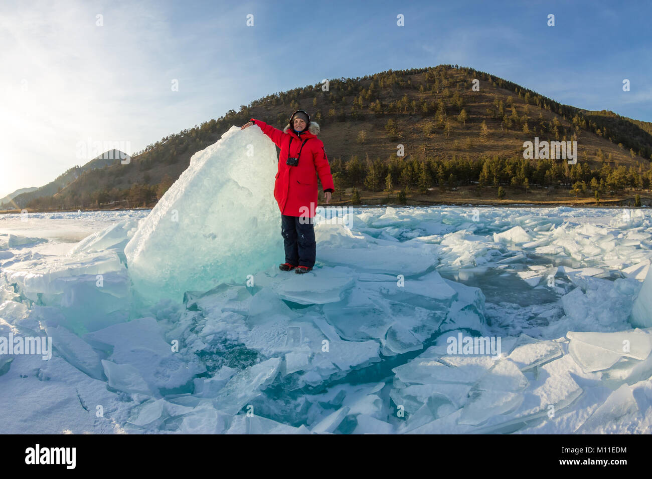 girl stands among the large blue ice ridges of Lake Baikal Stock Photo ...
