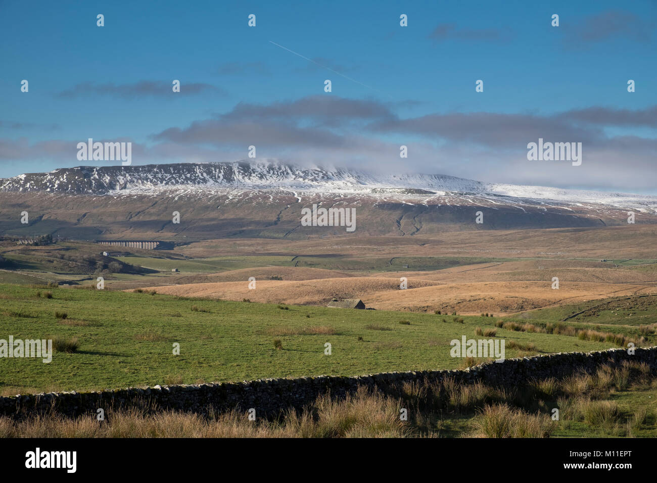 View of snowy Whernside and Ribble viaduct, North Yorkshire, England ...