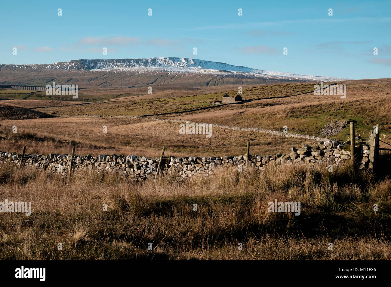 View of snowy Whernside and Ribble viaduct, North Yorkshire, England ...