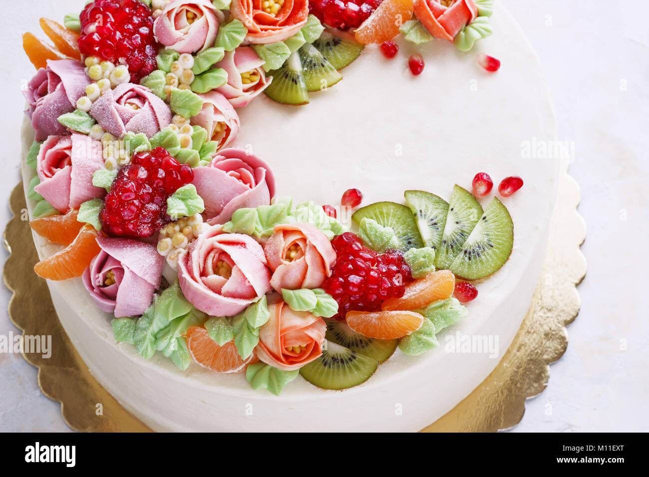Festive cake with cream flowers and fruits on a light background Stock ...