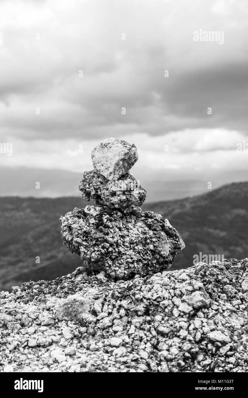 Beautiful stones superimposed in equilibrium on a concrete wall at the ...