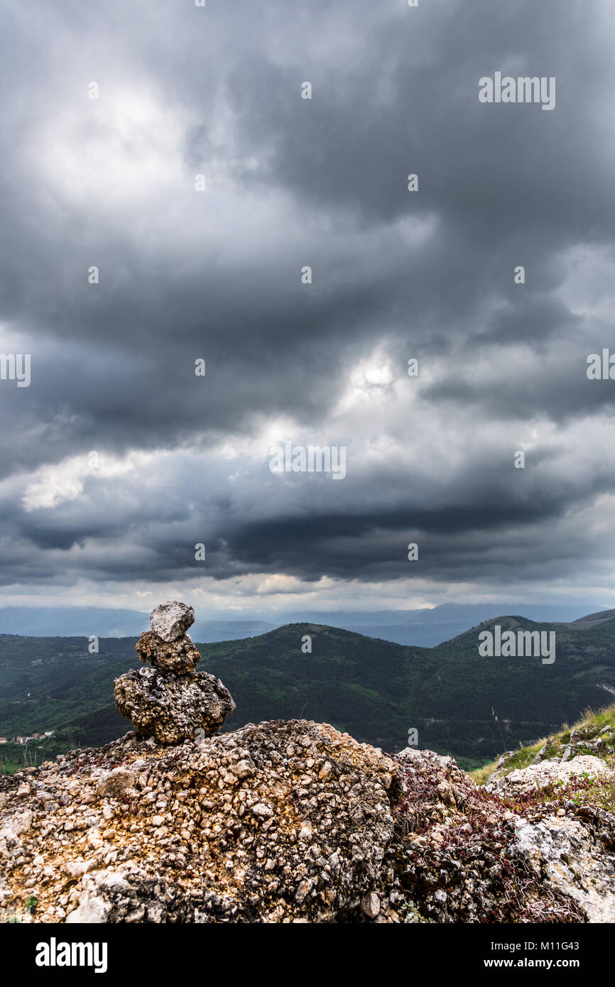 Beautiful stones superimposed in equilibrium on a concrete wall at the ...