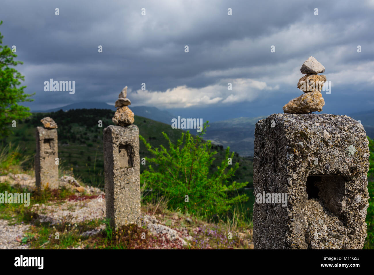 Beautiful stones superimposed in equilibrium on a concrete wall at the ...