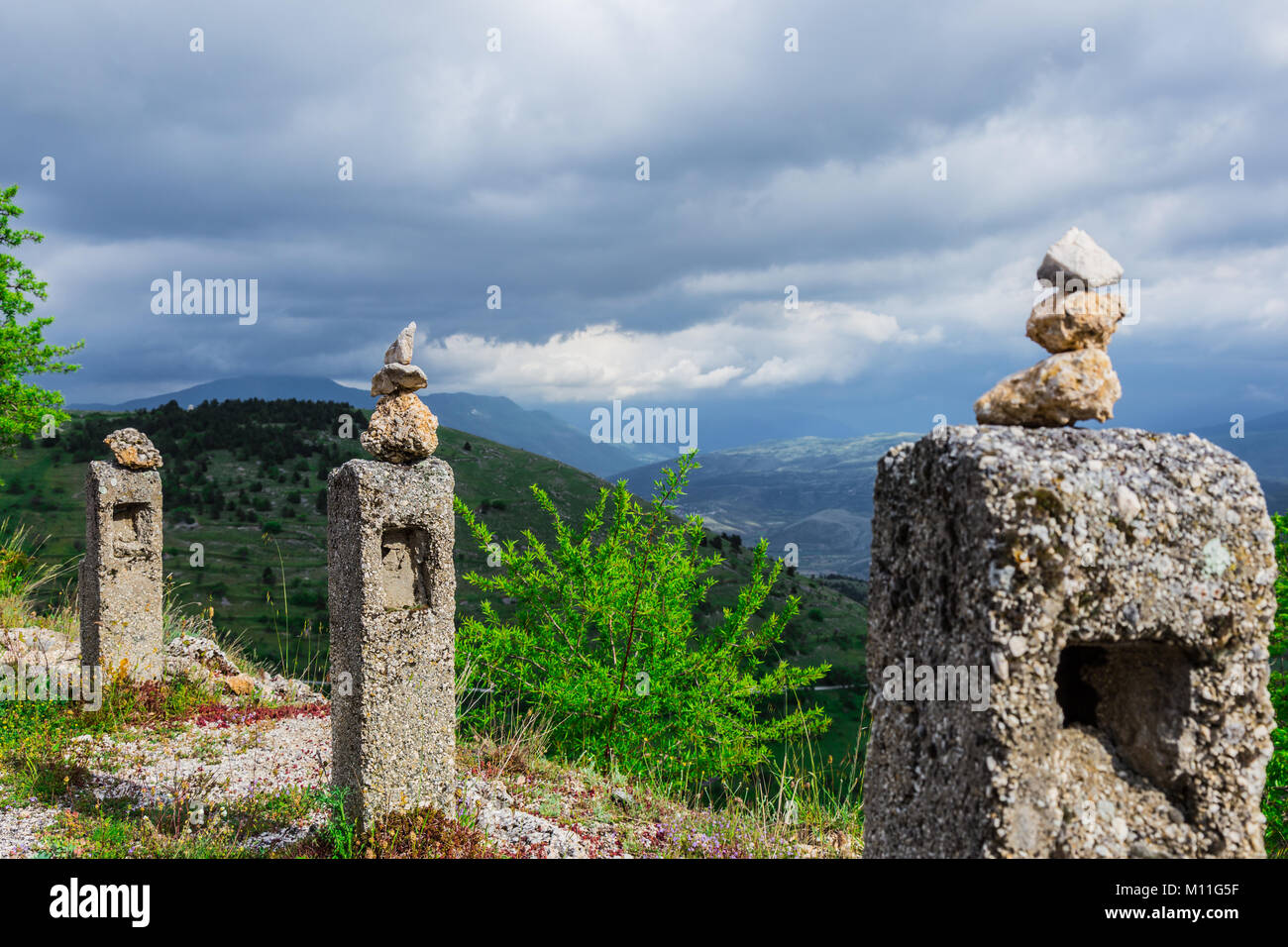 Beautiful stones superimposed in equilibrium on a concrete wall at the ...