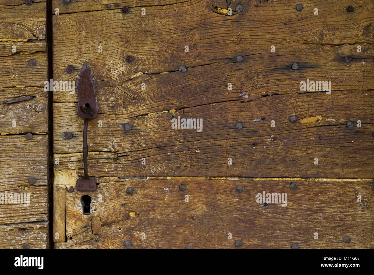 Ancient studded wood door full frame background close up Stock Photo ...