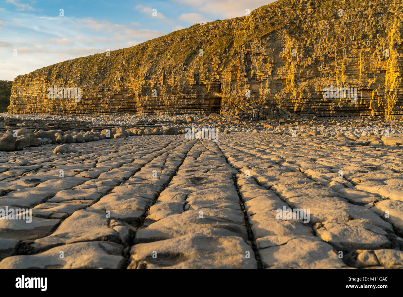The stones and cliffs of Llantwit Major Beach in the evening sun, South ...