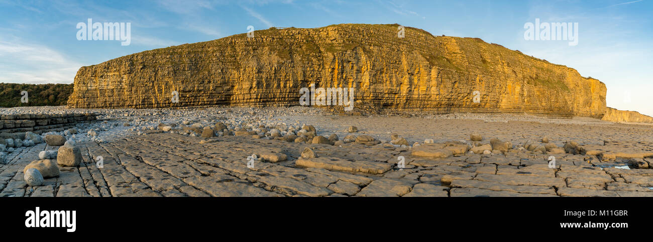 The stones and cliffs of Llantwit Major Beach in the evening sun, South ...