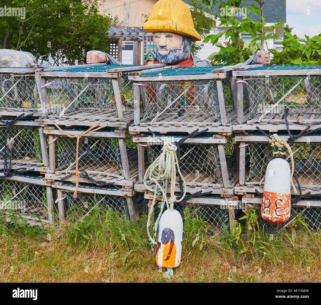 Lobster pots and model of fisherman, Pleasant Bay, Nova Scotia, Canada ...