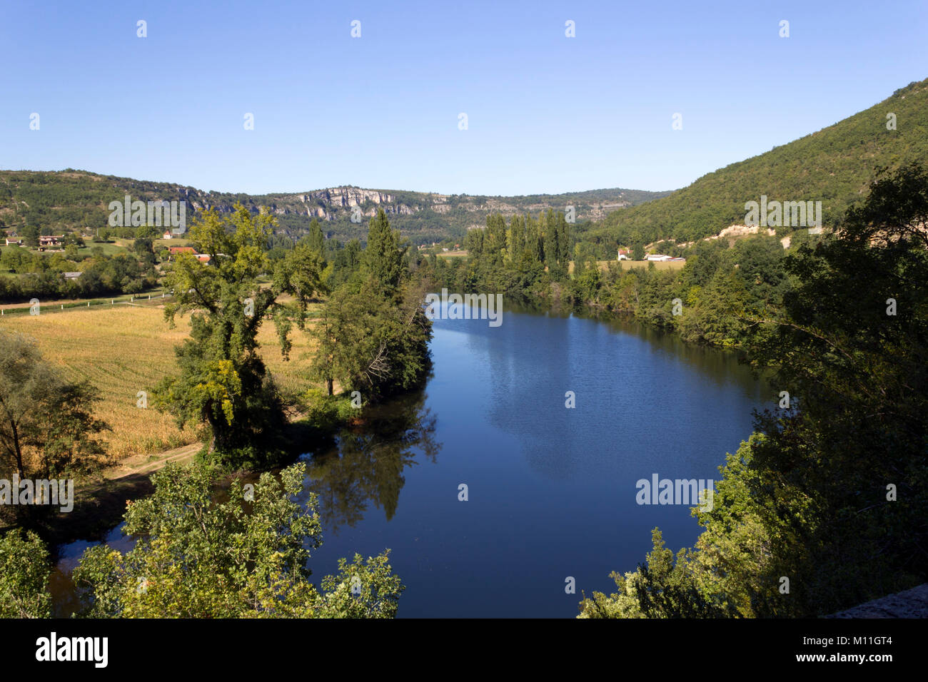 The peaceful River Lot flowing through rural countryside near Cajarc ...