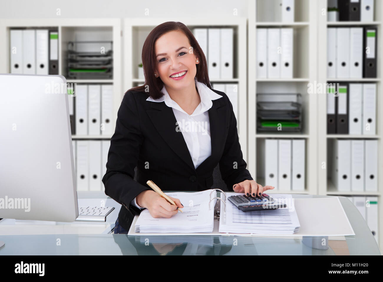 Portrait Of A Happy Accountant Woman Calculating Invoice Stock Photo ...
