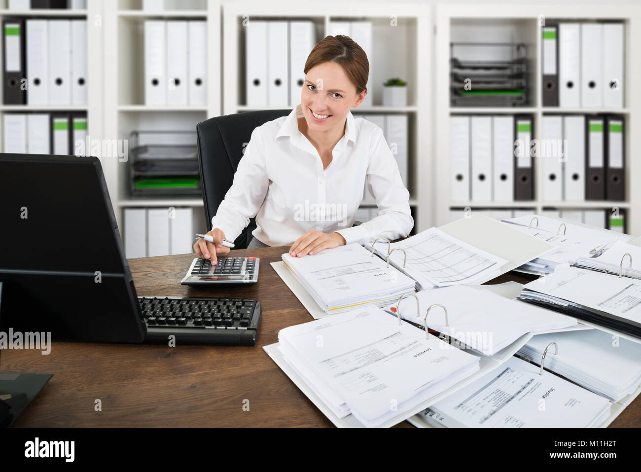 Beautiful female accountant analyzing hi-res stock photography and ...