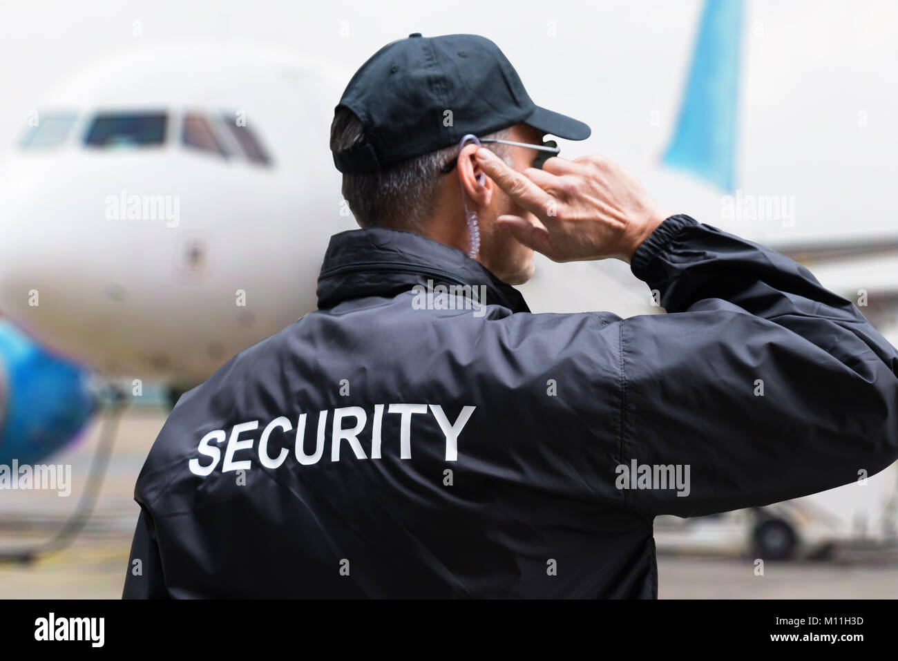 Rear View Of A Security Guard Wearing Black Jacket Stock Photo - Alamy