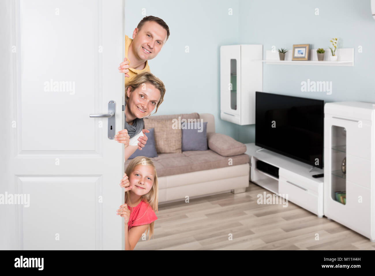 Man peeking door hi-res stock photography and images - Alamy