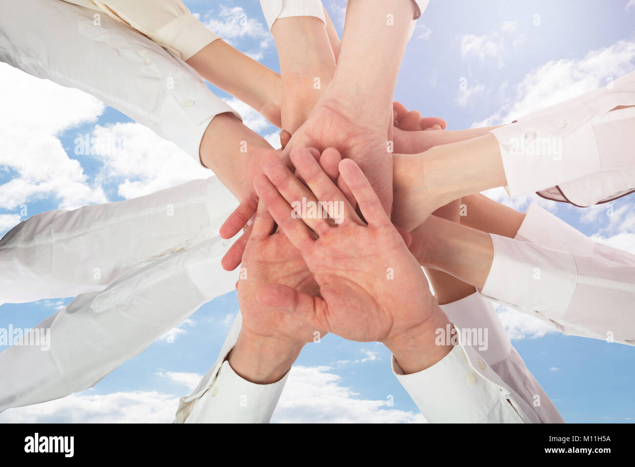 Low Angle View Of Multiracial Restaurant Staff In Uniform Stacking ...