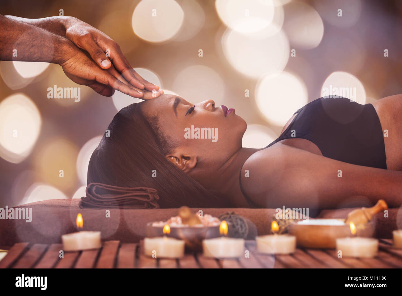 Young African Woman Receiving Forehead Massage By Male Therapist Stock ...