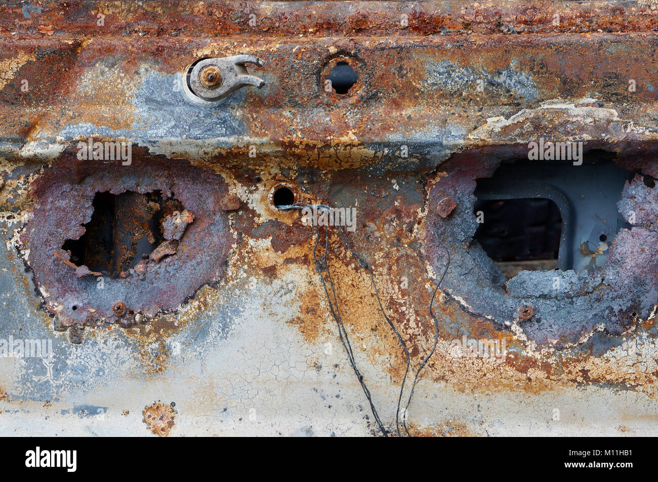 Two through holes in the old rusty car body textured background Stock ...