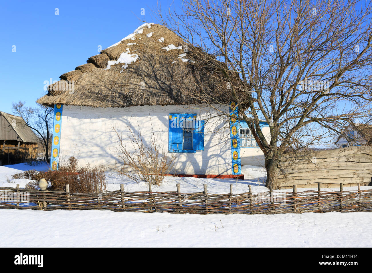traditional ukrainian house with thatch roof in sunny winter day Stock ...