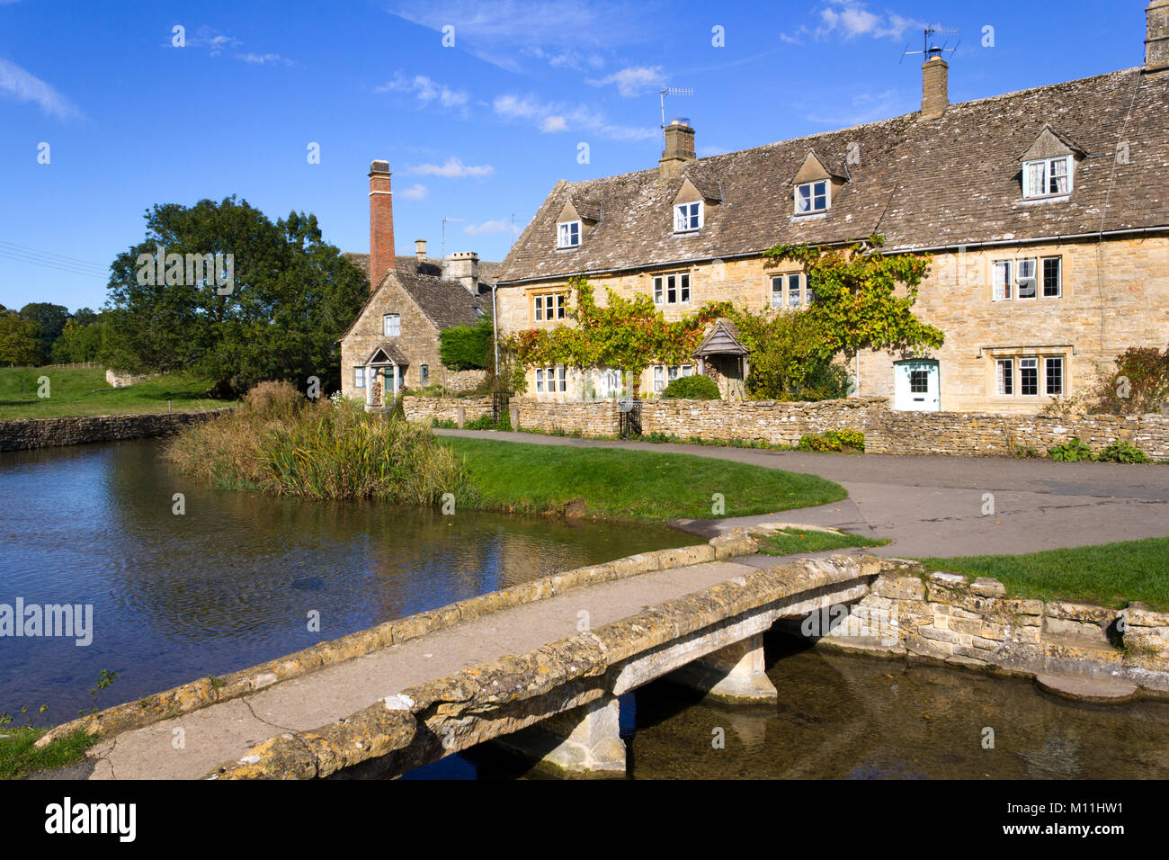 Idyllic old stone cottages at Lower Slaughter in autumn sunshine ...