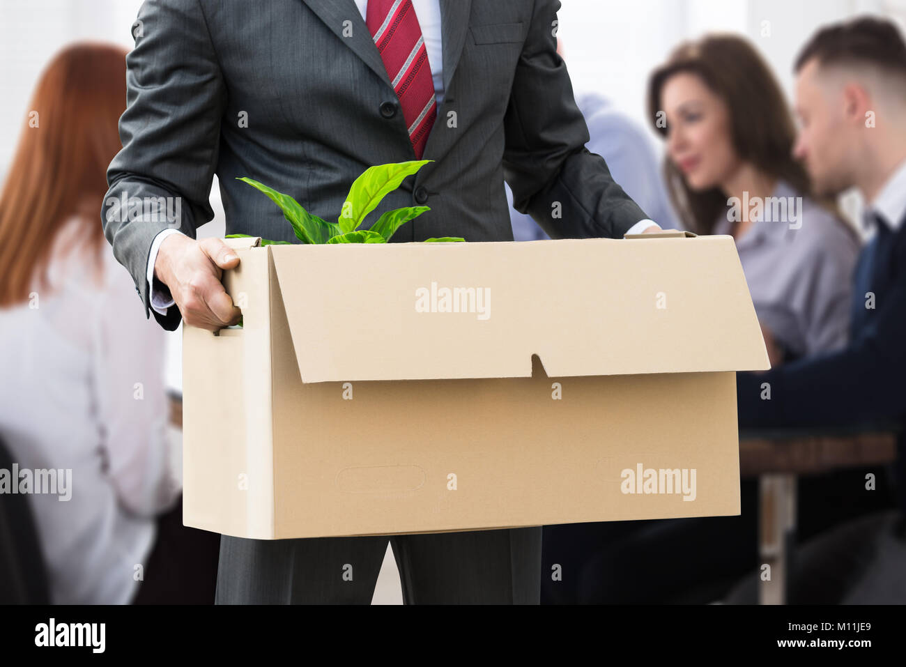 Office person holding box hi-res stock photography and images - Alamy