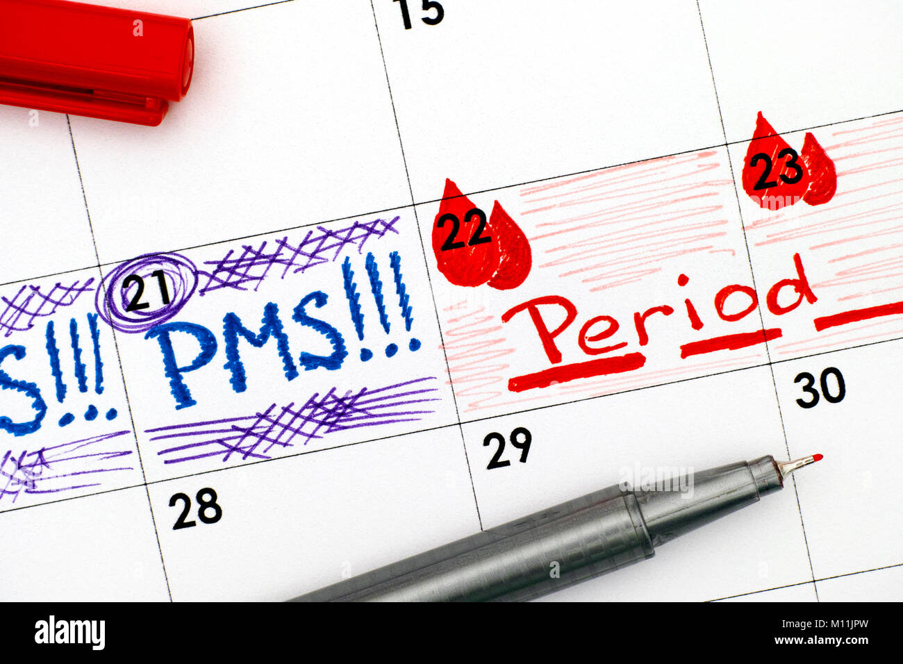 Reminder PMS and Period in calendar with red pen. Close-up Stock Photo ...