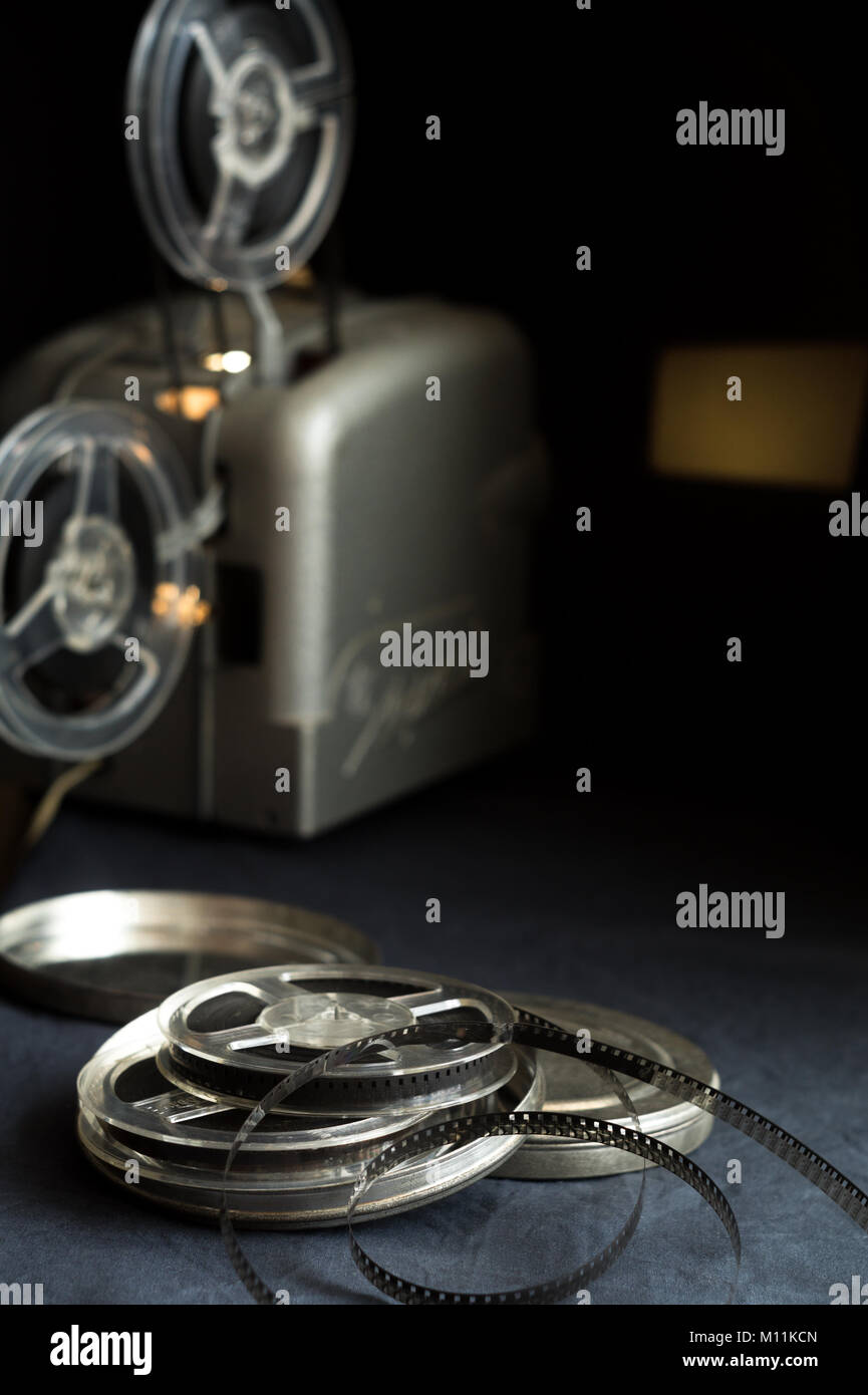 Old film projector and cassettes in the dark Stock Photo - Alamy