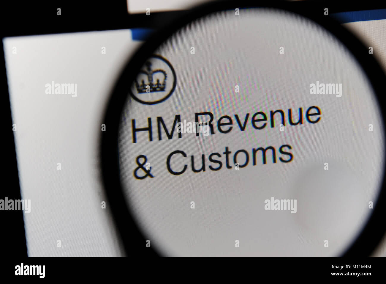 HM Revenue & Customs website seen through a magnifying glass Stock ...