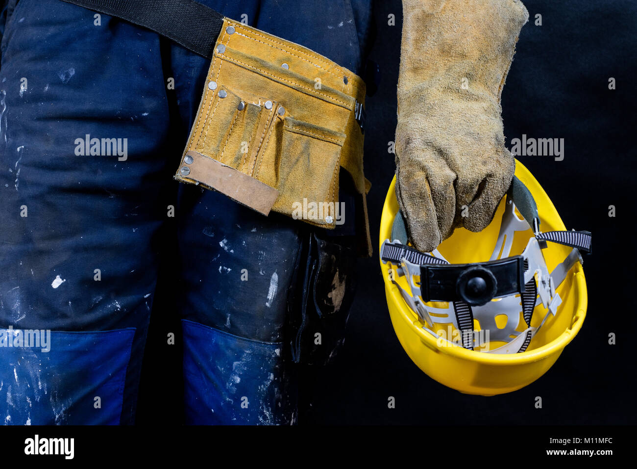 Workwear for production workers. A construction worker holding ...
