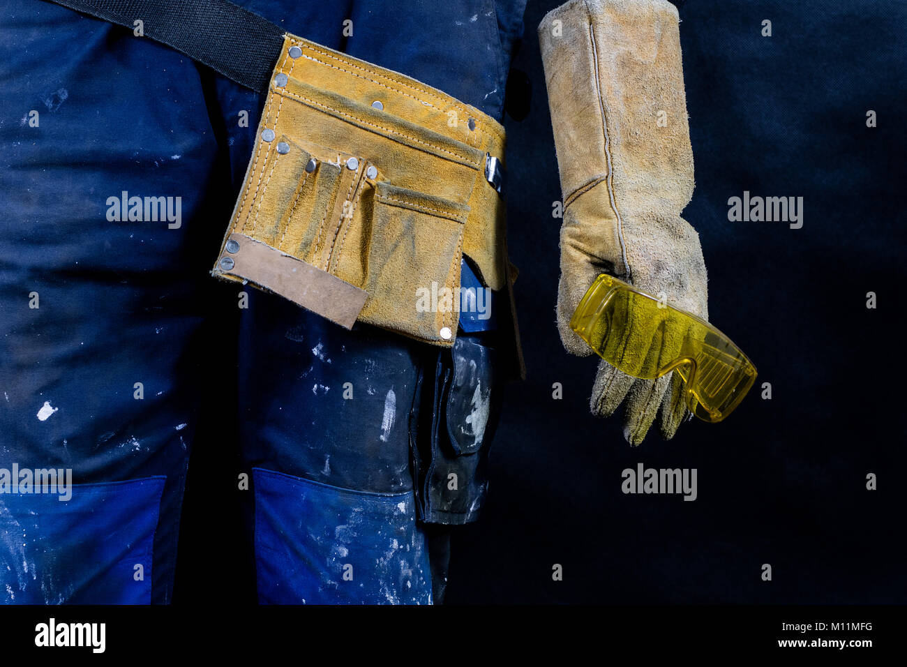 Workwear for production workers. A construction worker holding ...