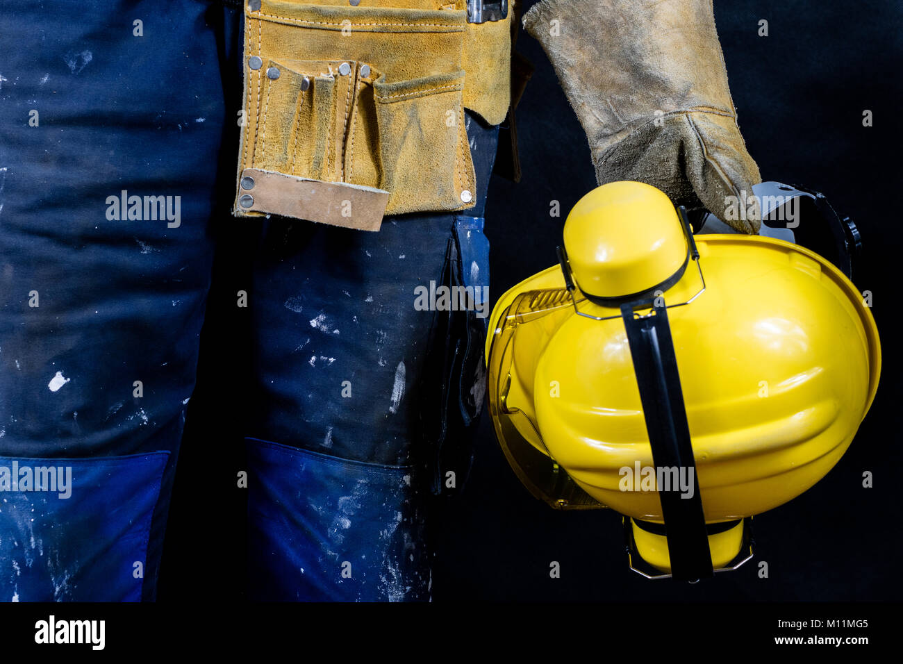 Workwear for production workers. A construction worker holding ...