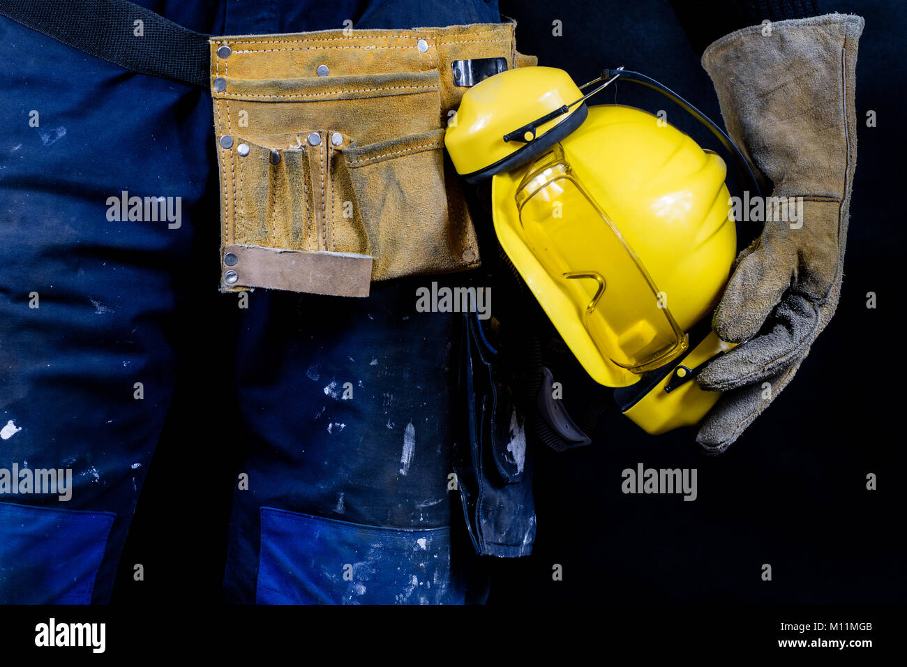 Workwear for production workers. A construction worker holding ...