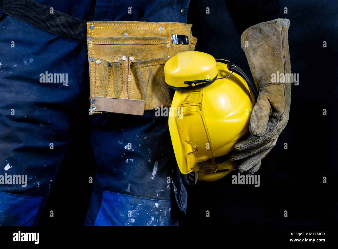 Workwear for production workers. A construction worker holding ...