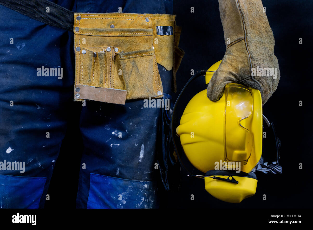 Workwear for production workers. A construction worker holding ...