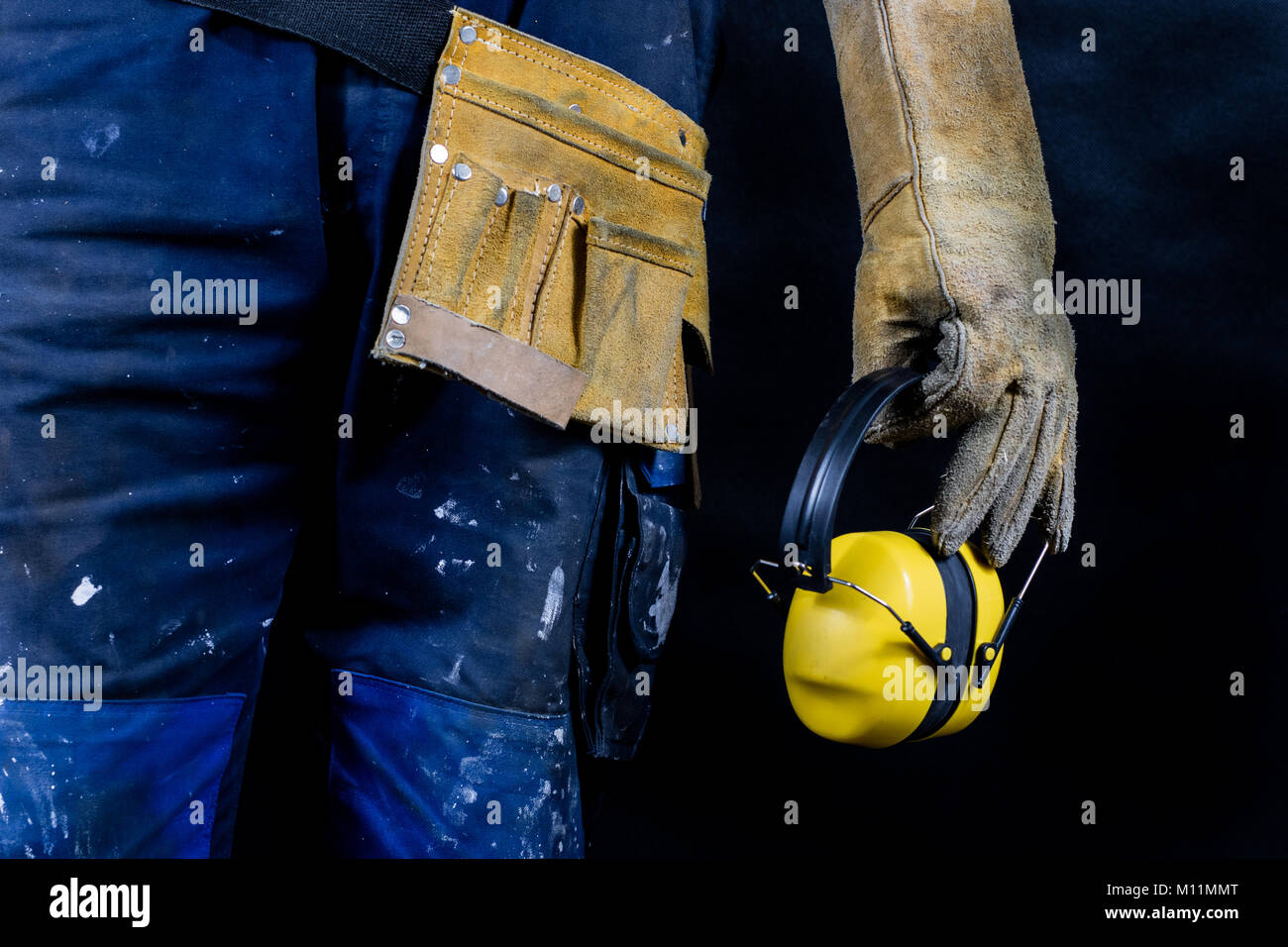 Workwear for production workers. A construction worker holding ...