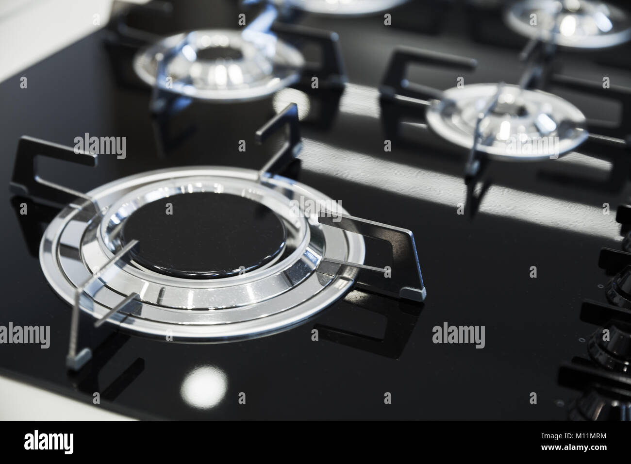 Modern gas stove burner made of shiny stainless steel and black ...