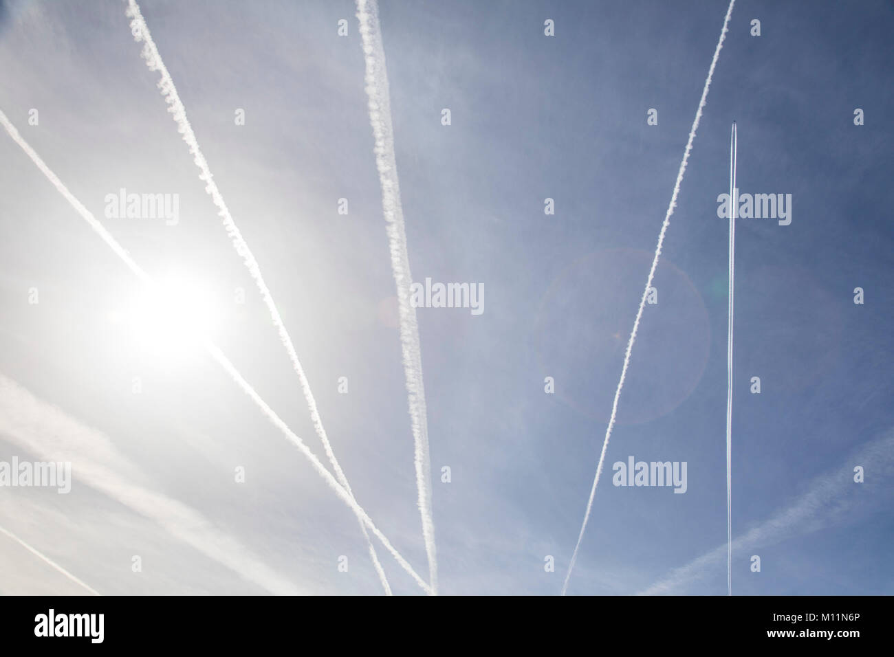 Contrails in the sky over the North Sea island Norderney, Germany ...