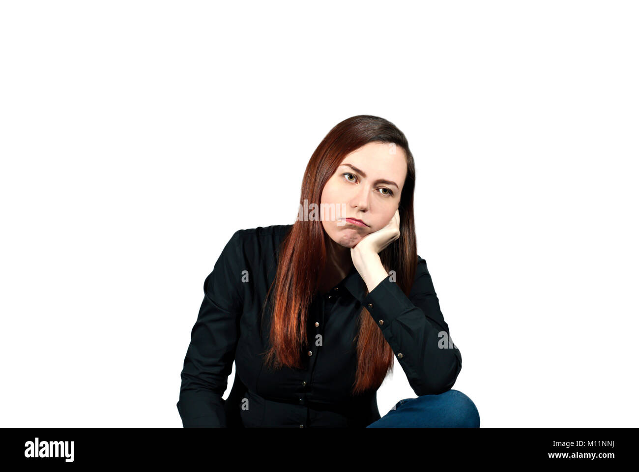girl on a white background sits in a pose expressing boredom or gloomy ...