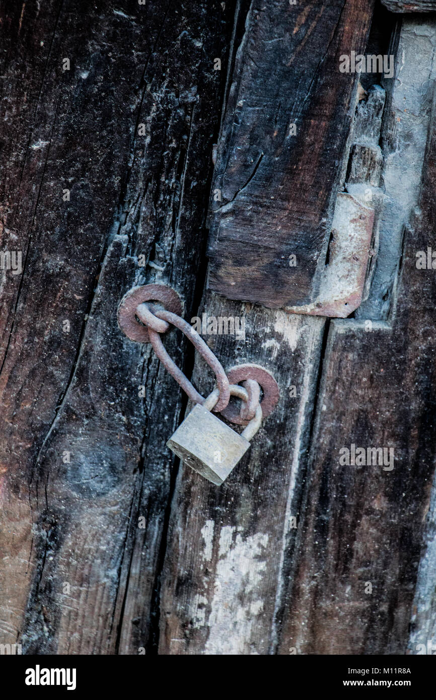 The Old rusted metal lock in metal chains Stock Photo - Alamy