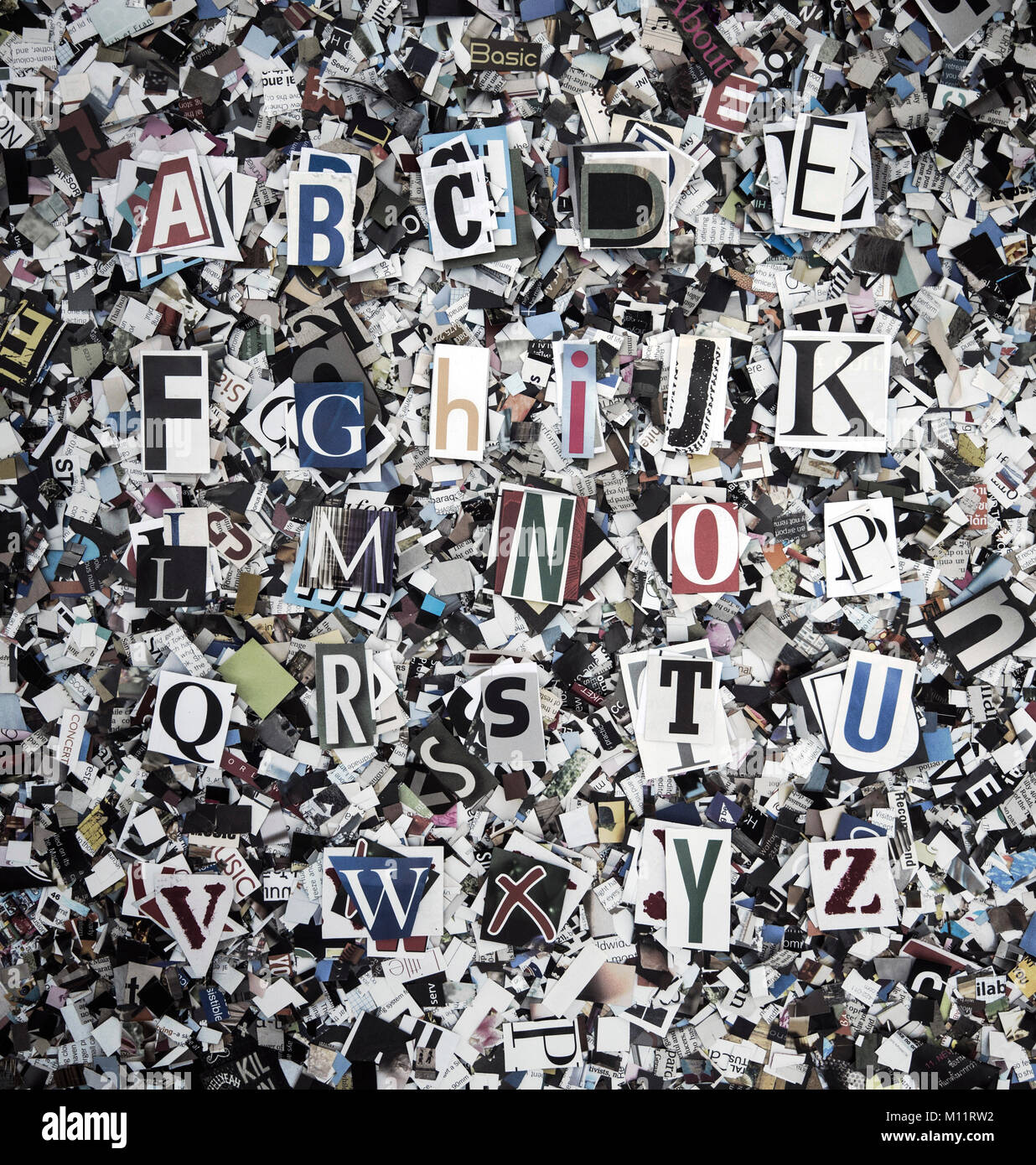 A random selection of word cut out from old magazines with confetti ...