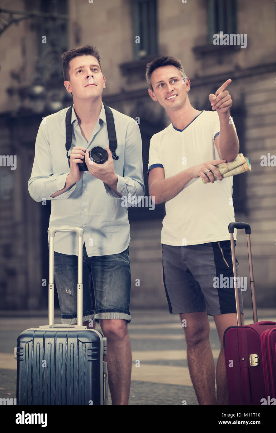 Male travelers with luggage making photo at the city on vacation Stock ...