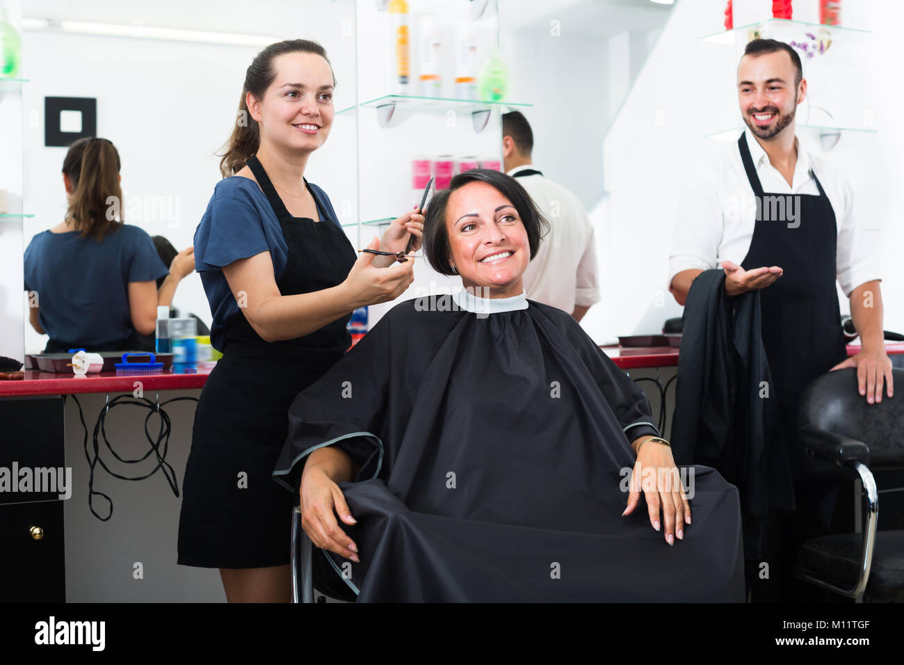 Woman hairdresser cutting female client in beauty salon Stock Photo - Alamy