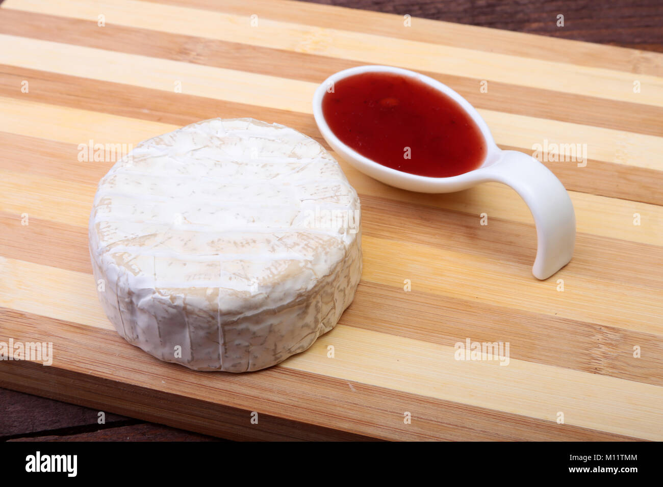 Cheese with white mold. Camembert or brie type with Cranberry sauce ...