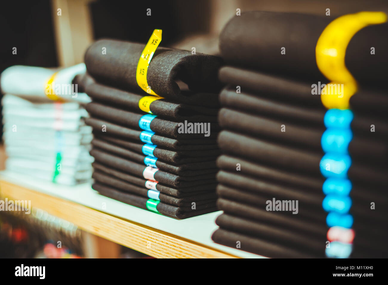 sale shopping background. clothes on shelves in store Stock Photo - Alamy